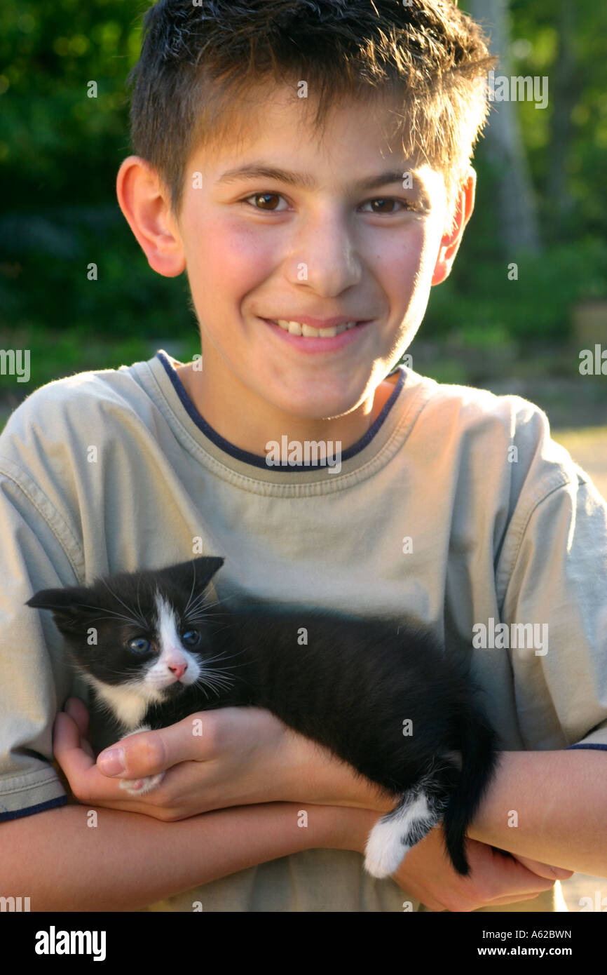 portrait of a young boy holding a kitten in his arms Stock Photo - Alamy