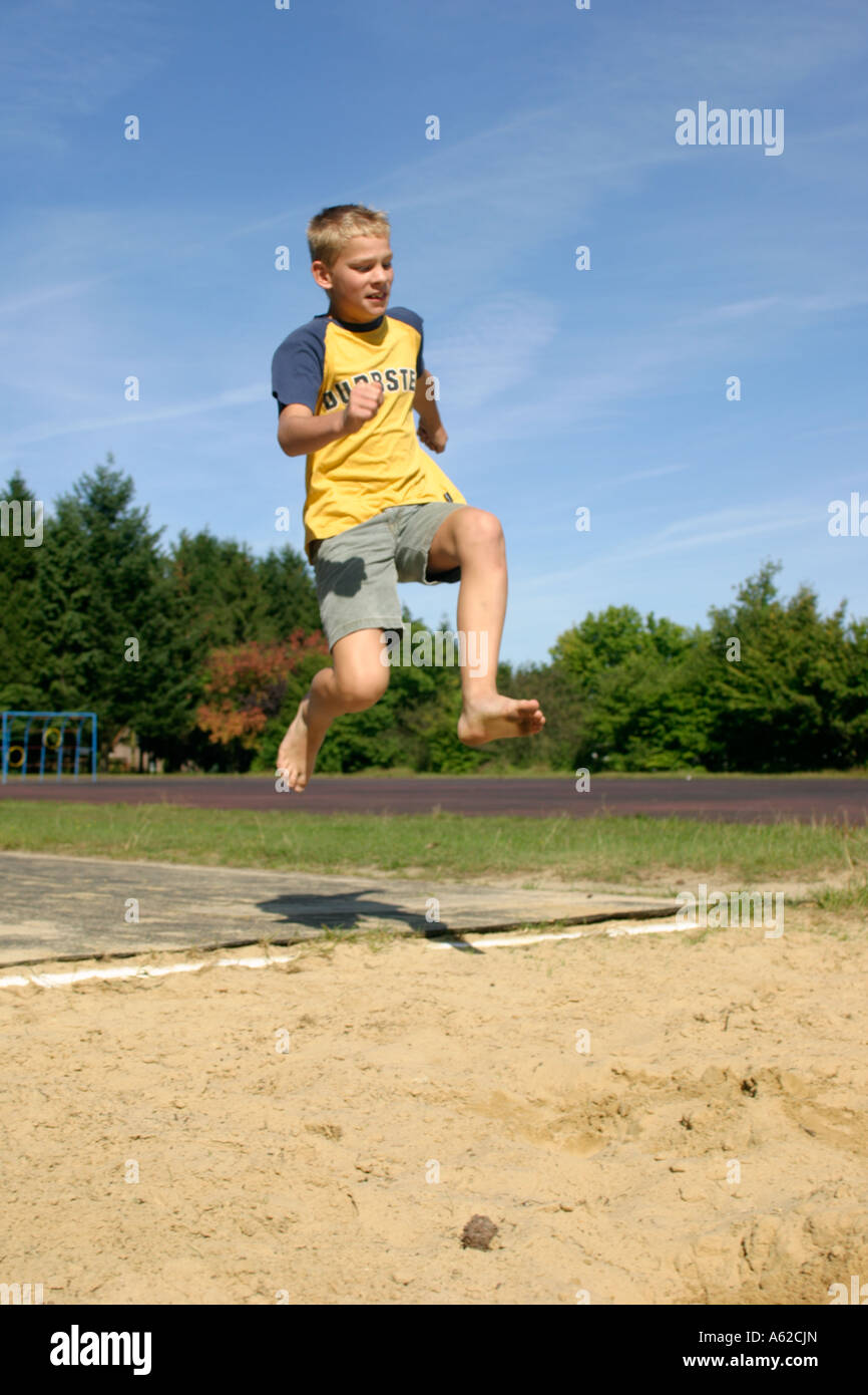 young boy practising the long jump in a sports field Stock Photo - Alamy