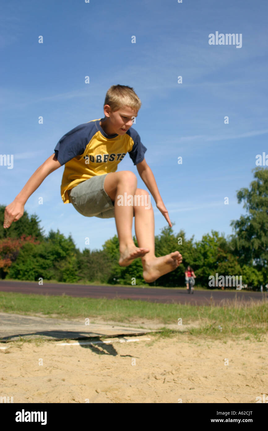 young boy practising the long jump in a sports field Stock Photo - Alamy