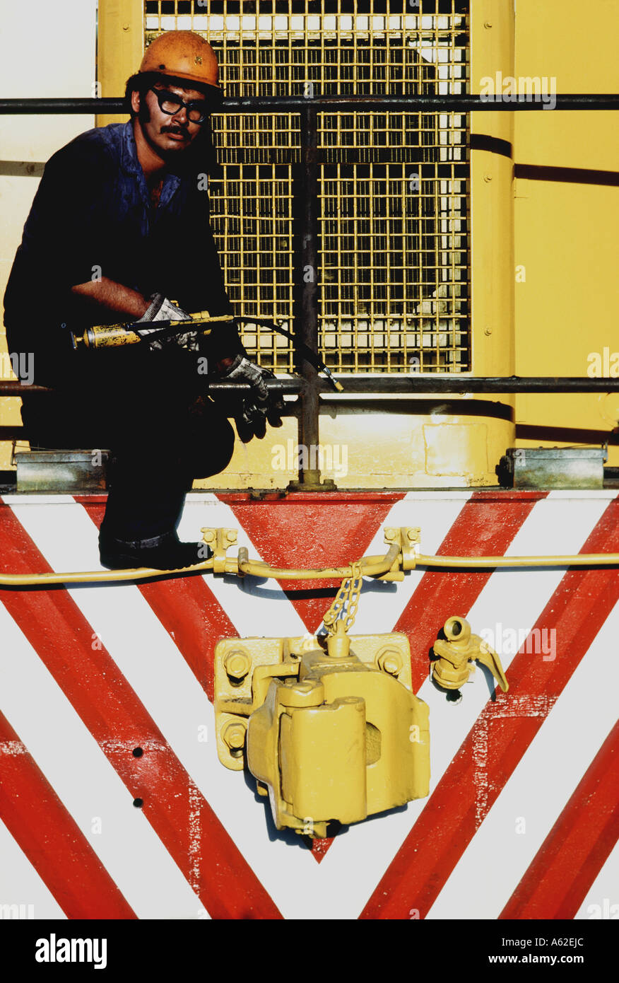 A train engineer poses for the camera while working on the train Stock ...
