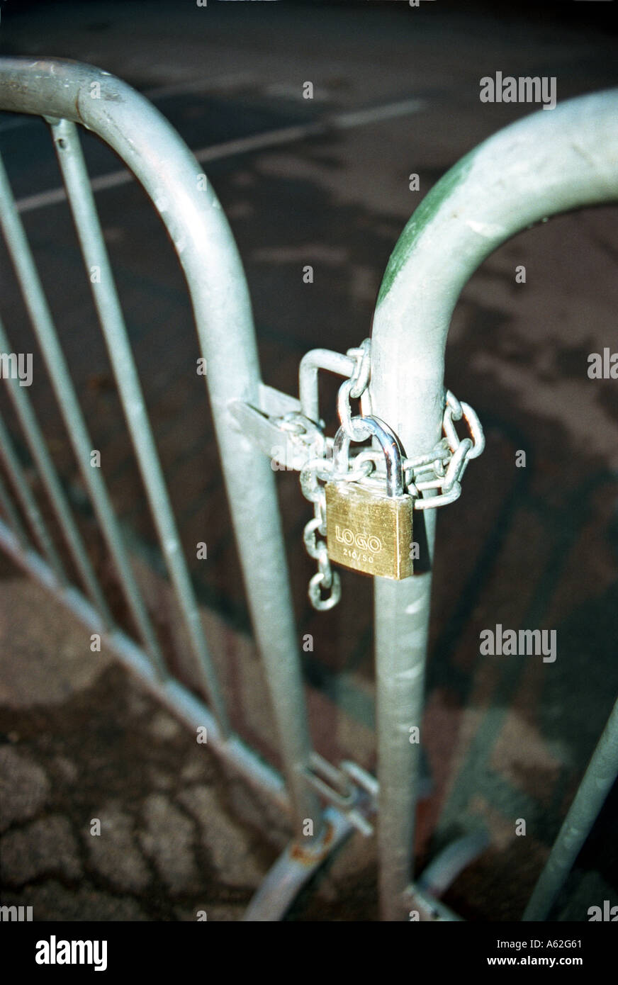 barrier entry closed with lock and chain at night Stock Photo - Alamy