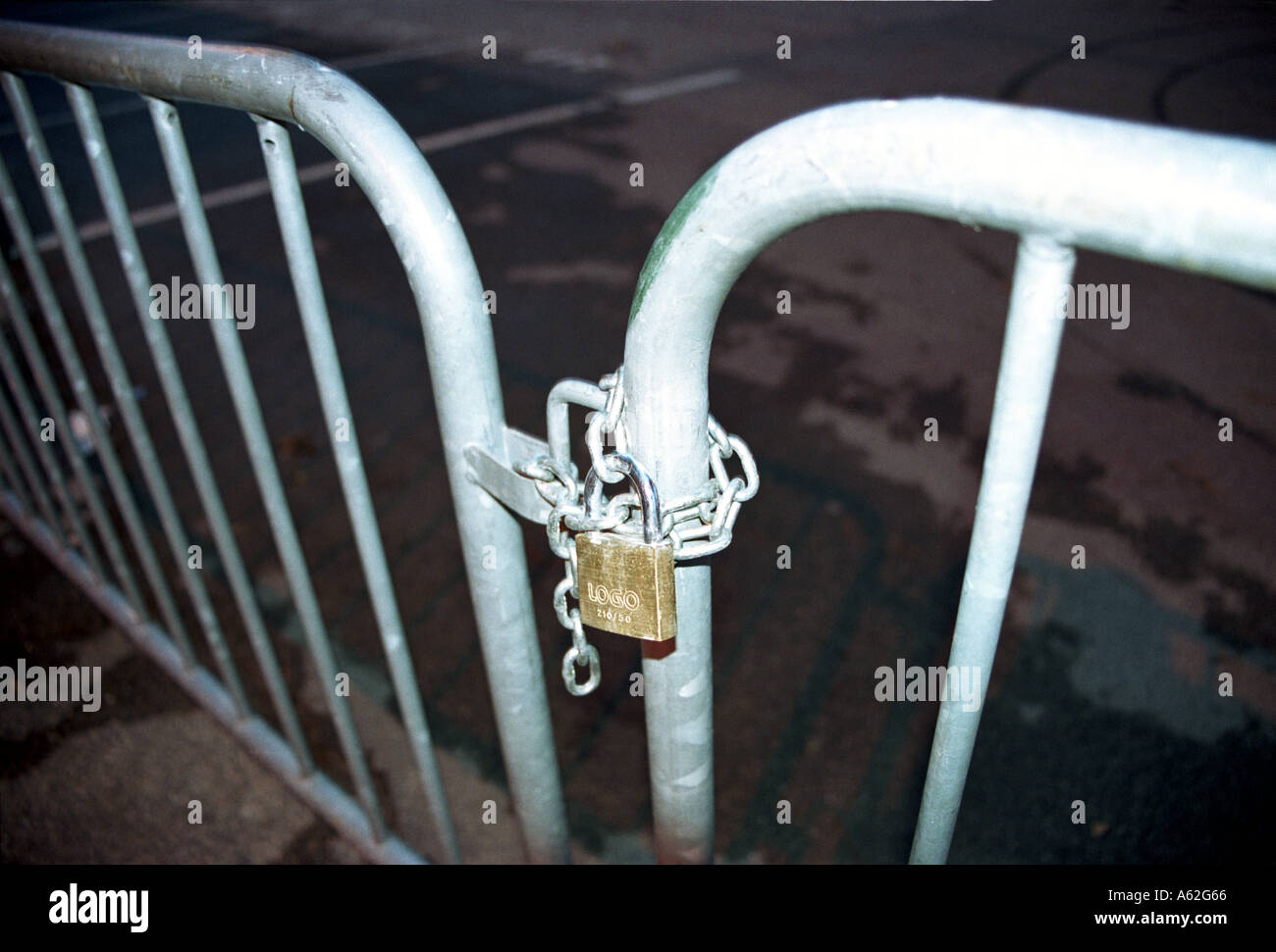 barrier entry closed with lock and chain at night Stock Photo - Alamy