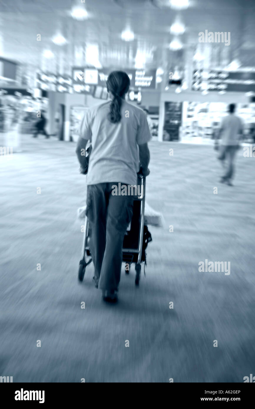 Man pushing trolley through Changi Airport, Singapore Stock Photo - Alamy