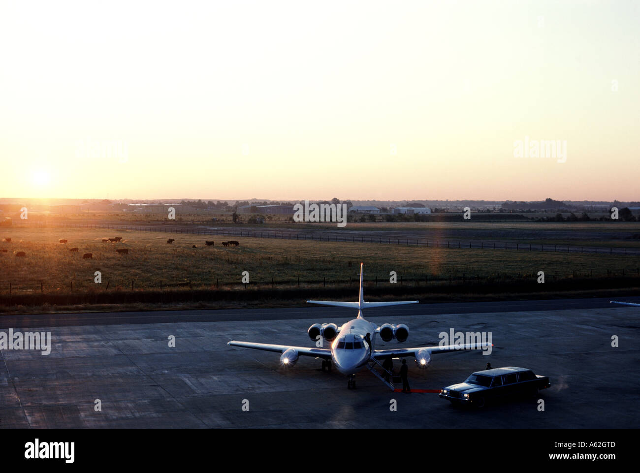 From above, a limousine can be seen pulling up to a company's corporate ...