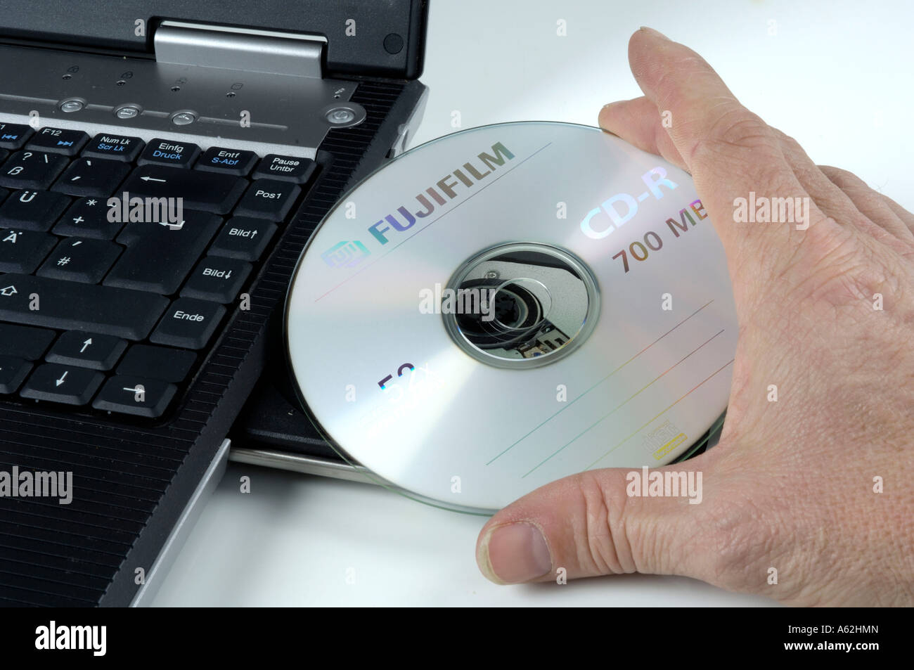 Putting cd in cd drive hi-res stock photography and images - Alamy