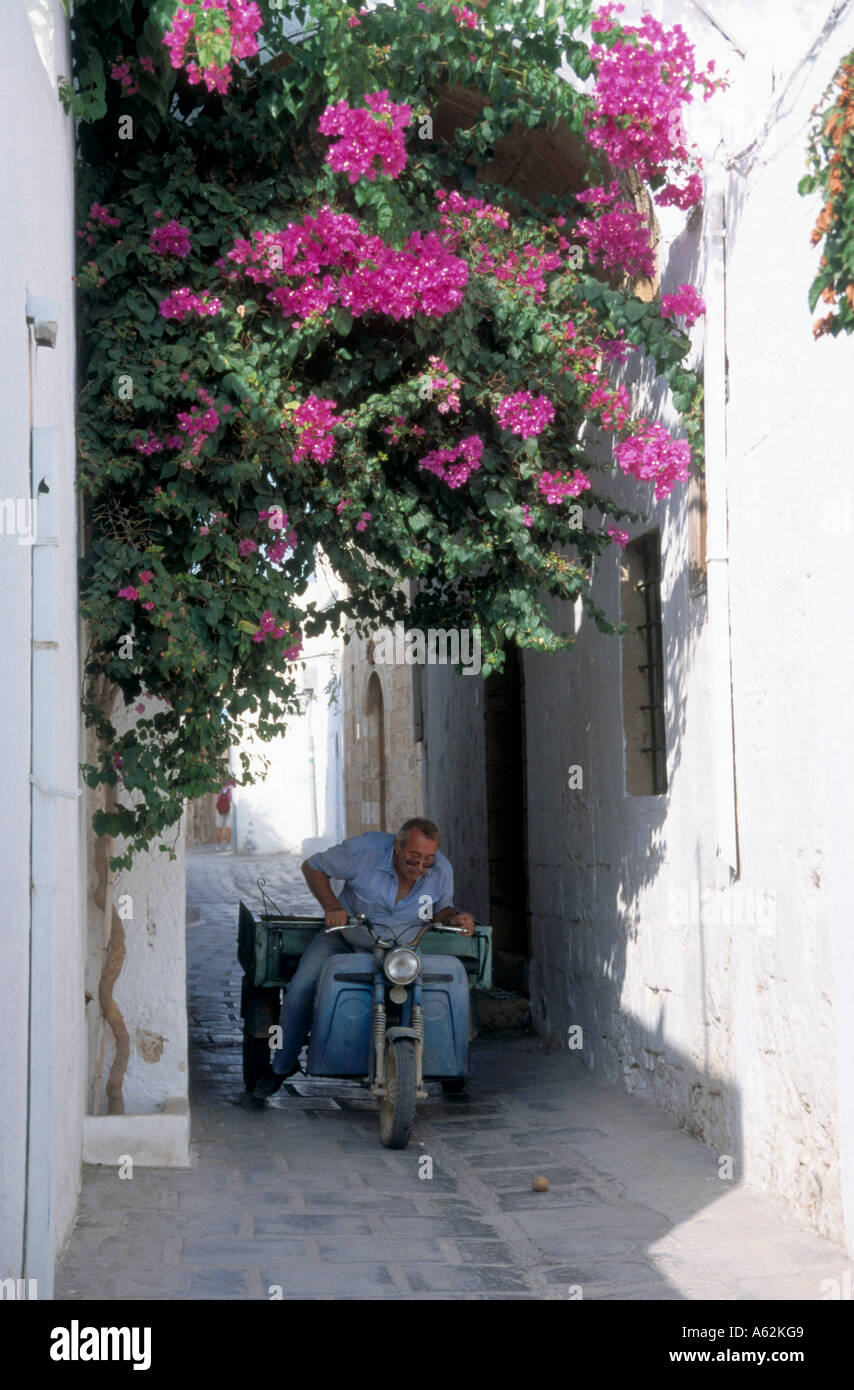 Senior man riding tricycle in street Stock Photo - Alamy