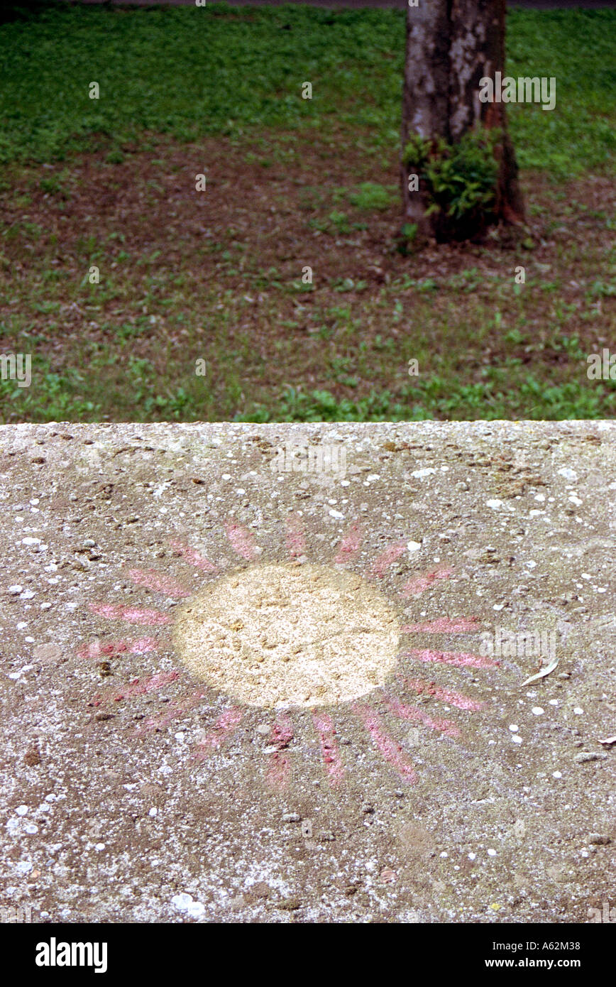 faded sun painted on wall with tree Stock Photo - Alamy