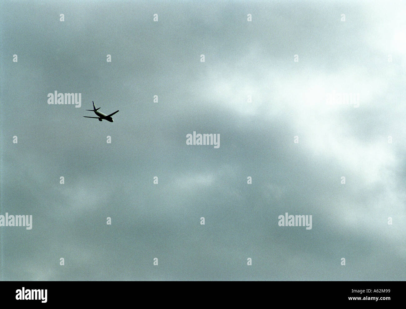 plane moving across cloudy sky Stock Photo - Alamy