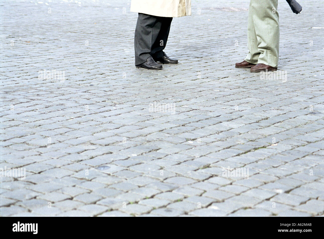 two businessman s legs facing each other on road Stock Photo - Alamy