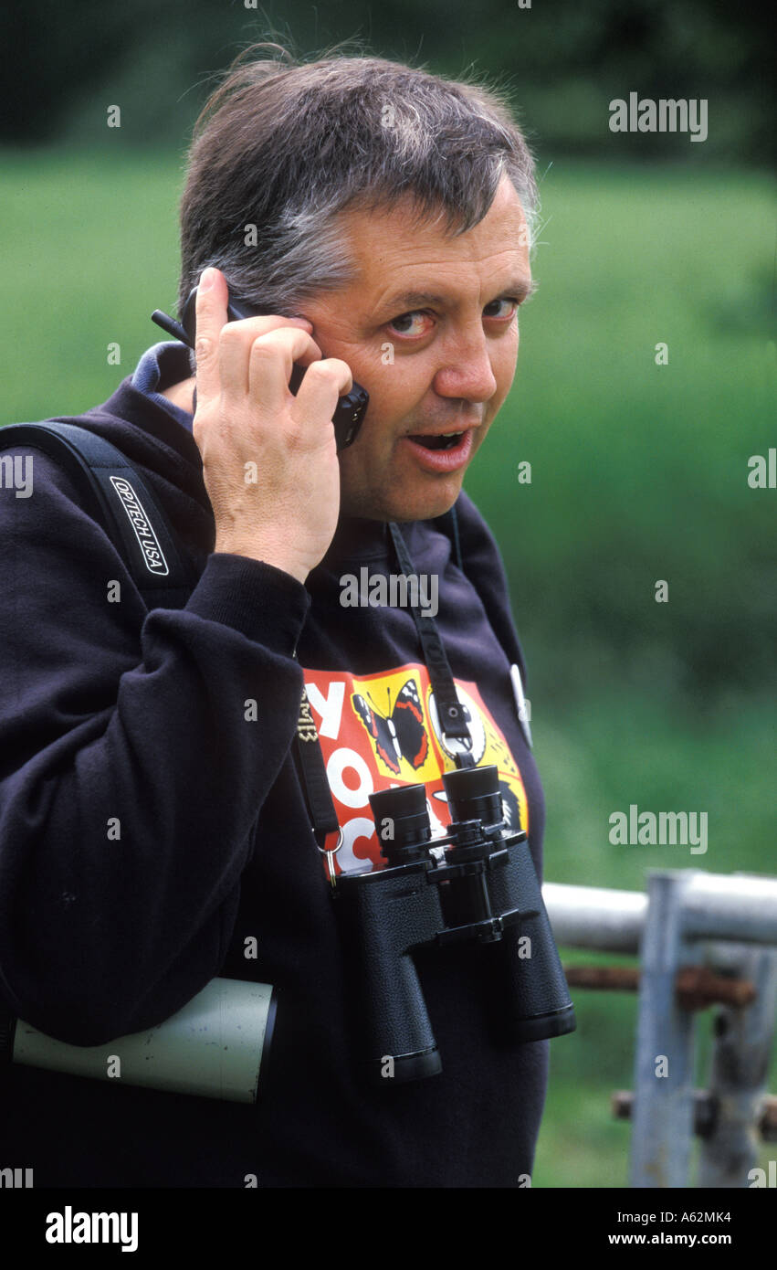 a bird watcher taking a phone call Stock Photo - Alamy