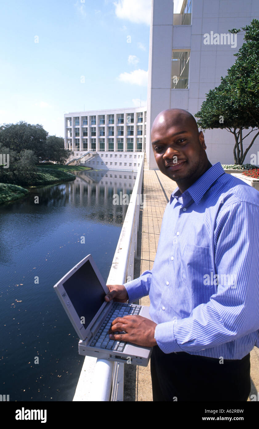 Black african american man outdoors communicating with computer in ...