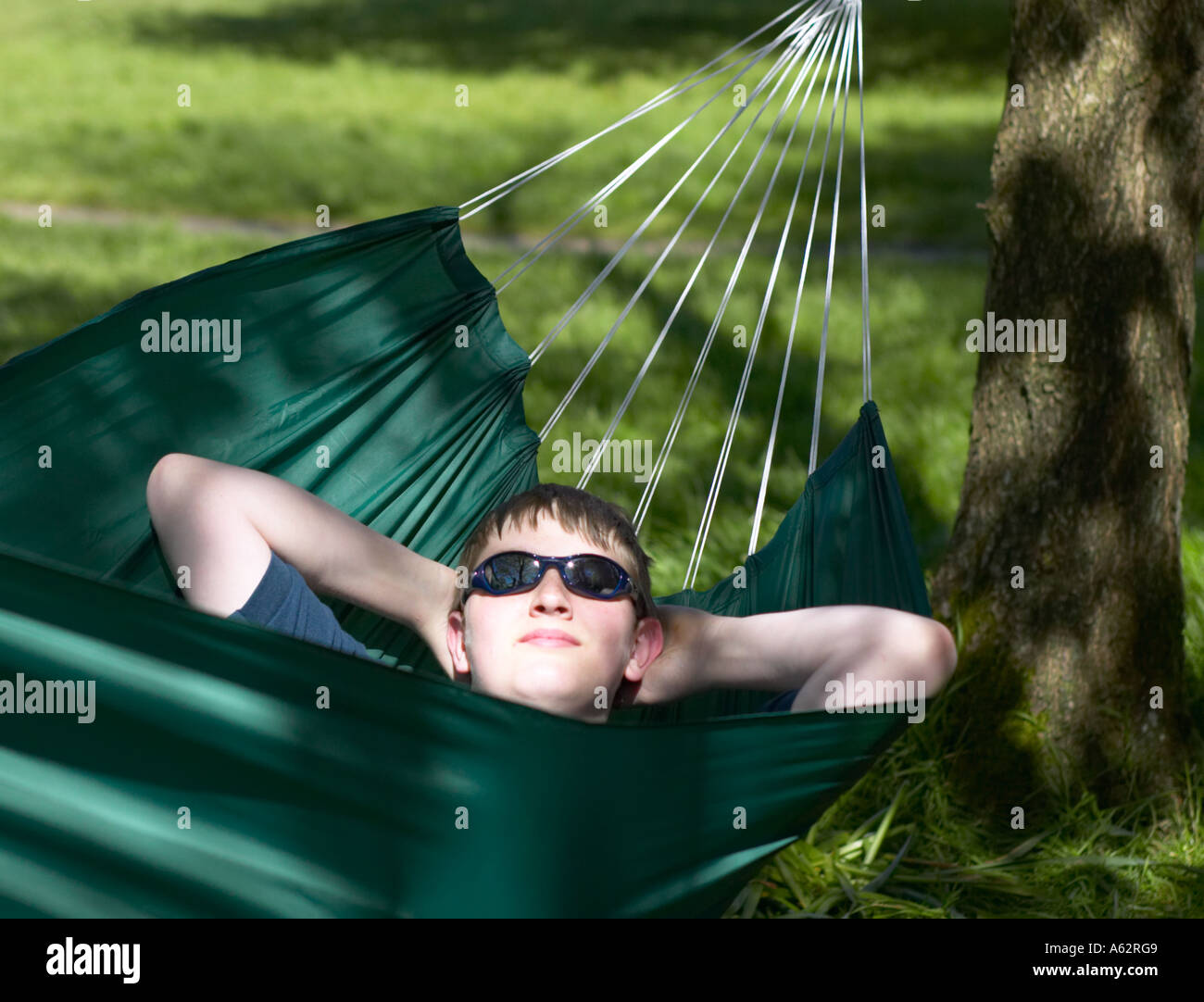 Young scout lounging in hammock Stock Photo - Alamy