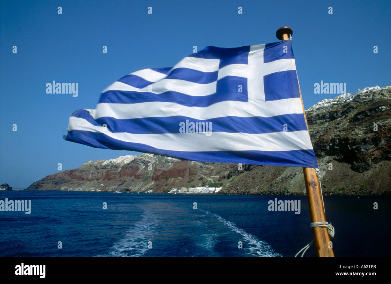 Greek flag fluttering in sea, Santorini, Greece Stock Photo - Alamy