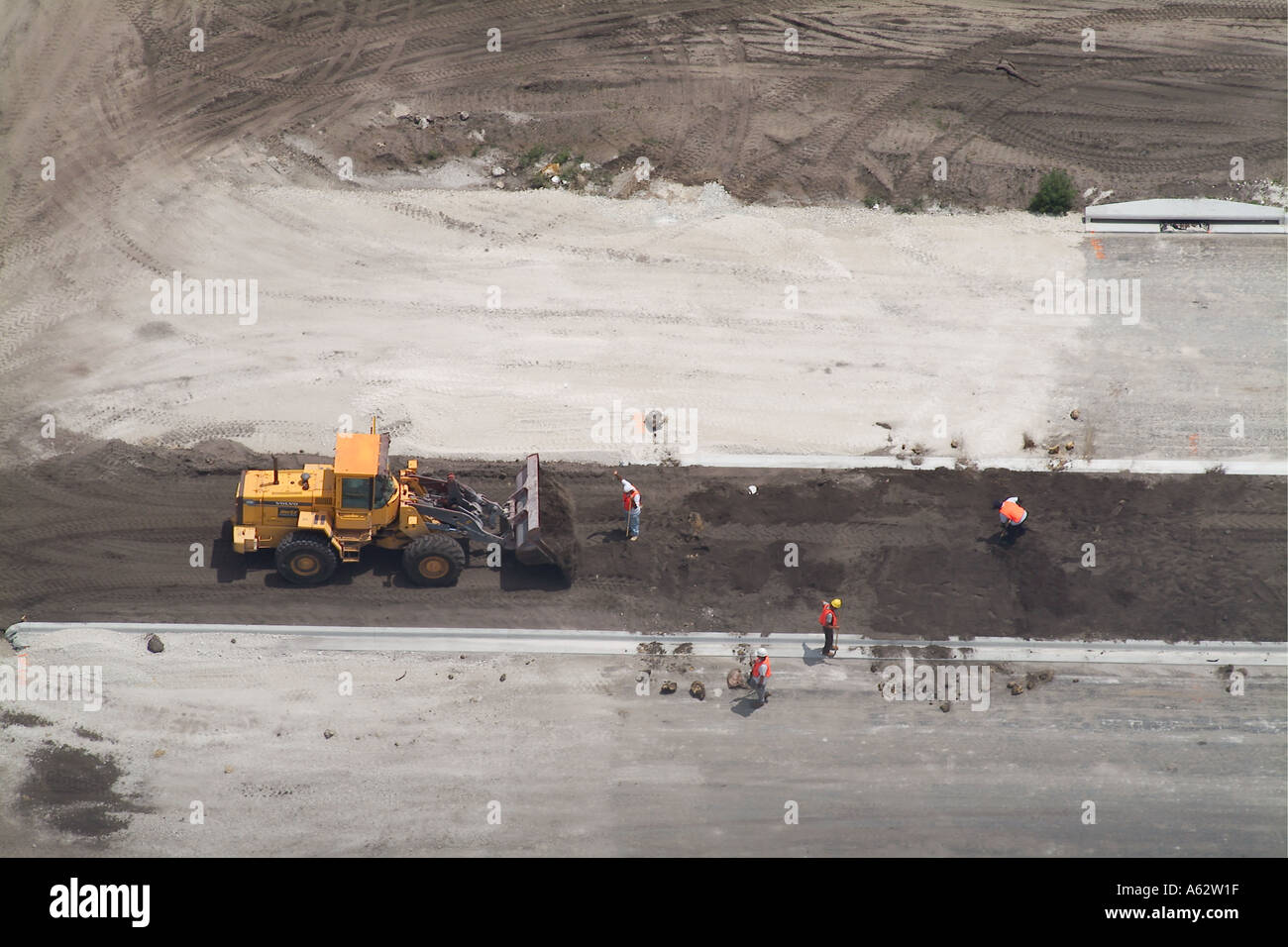 construction workers working at job building a road loader streets ...