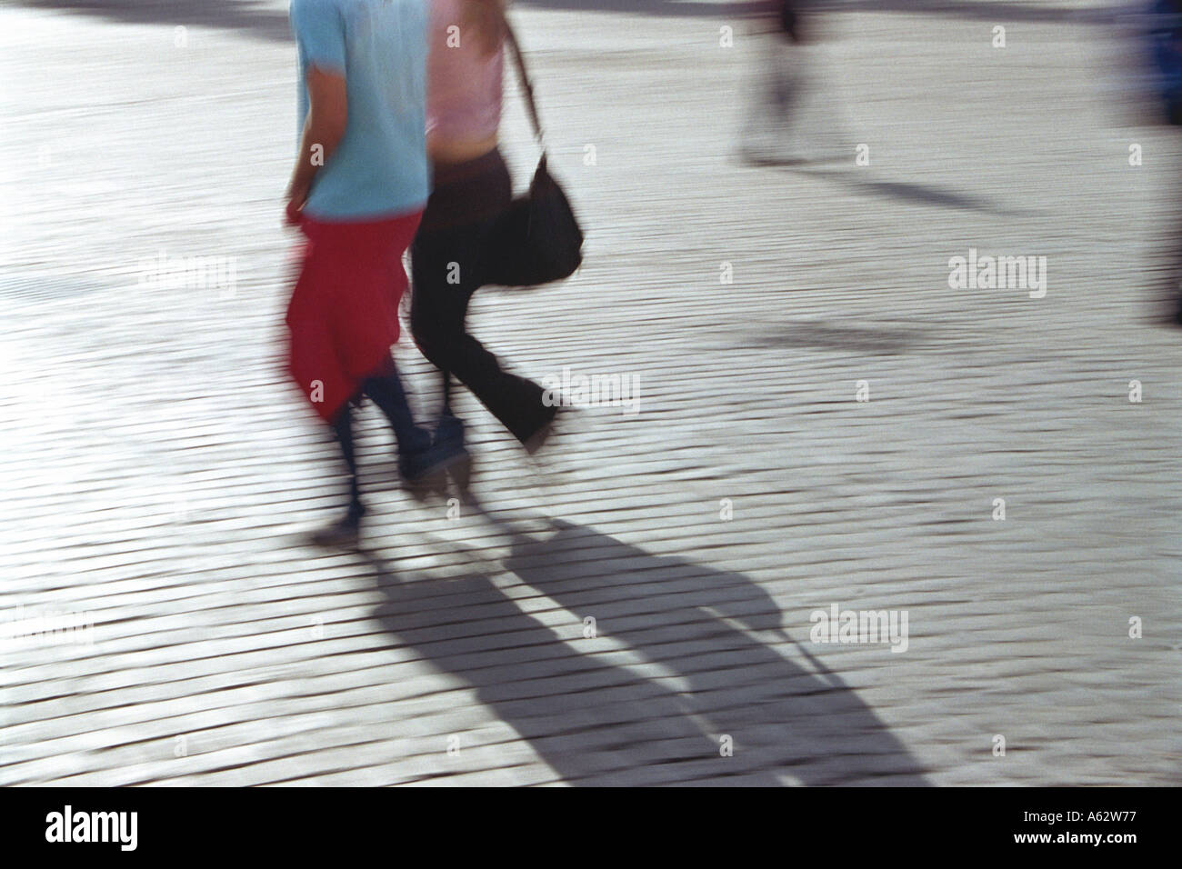detail of couple s moving legs in town blur Stock Photo - Alamy
