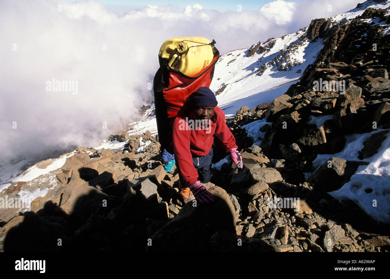 Porter carrying luggage to Kibo Crater campsite Kilimanjaro National ...