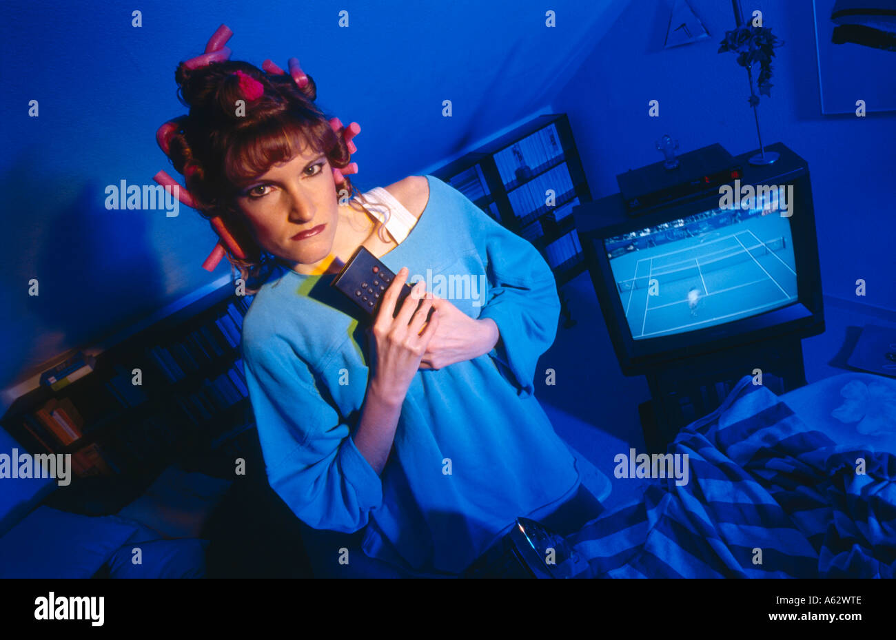 Portrait of a woman holding a remote control and looking angry Stock ...