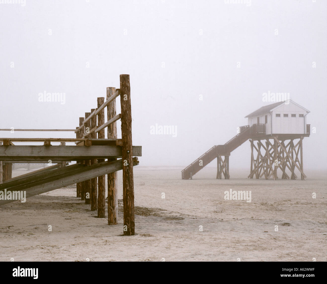 Fog over jetty and lifeguard hut on beach Stock Photo - Alamy