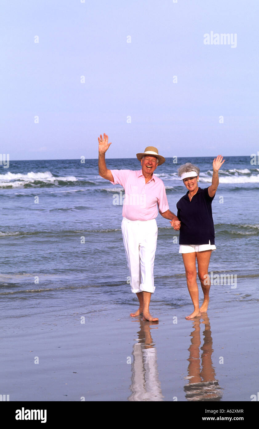Senior retired couple relaxing at the beach near the ocean Stock Photo ...