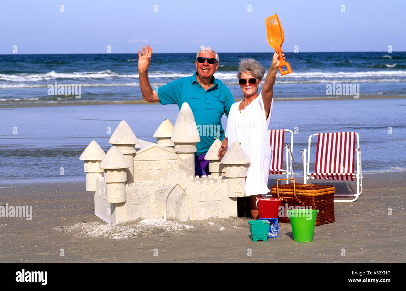 Senior retired couple relaxing at the beach near the ocean Stock Photo ...