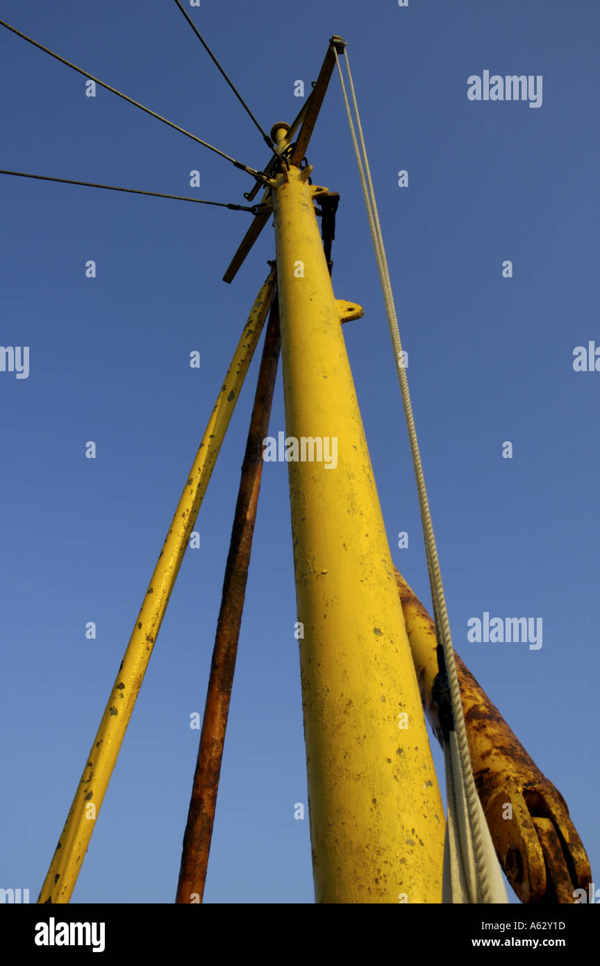 Old yellow rusty pylon in a pleasure port Stock Photo - Alamy
