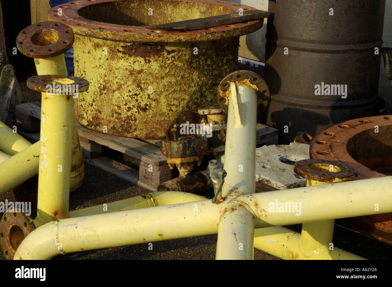 Old yellow rusty tubes in a port Stock Photo - Alamy