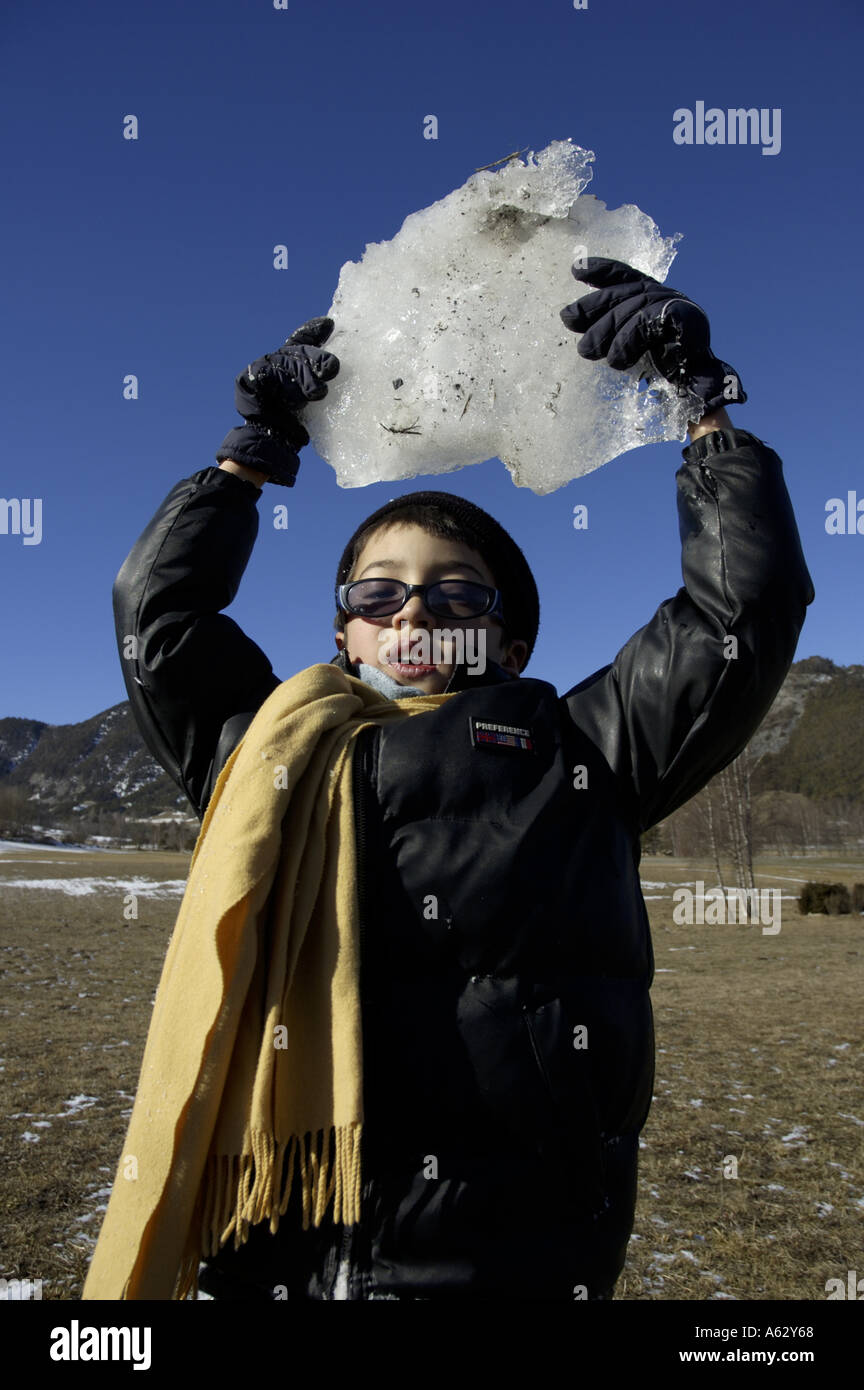 A children holding a piece of ice as a trophy Stock Photo - Alamy