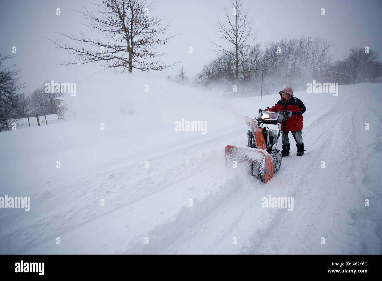 Young Boy Digging out from Snow Storm - Ithaca NY - Using snow blower ...
