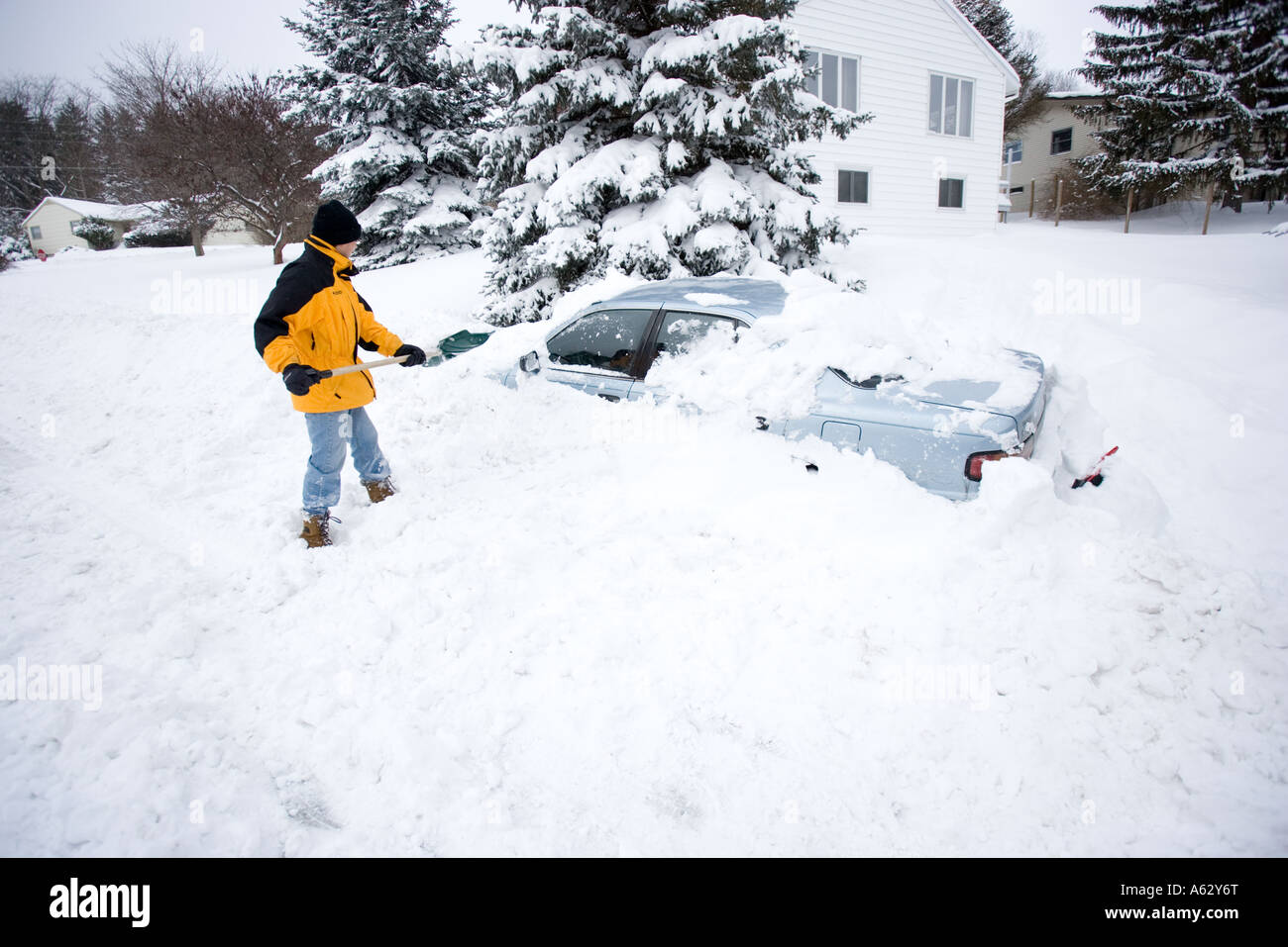 Young Man Digging out Car After Snow Storm Ithaca NY After 17 inch ...