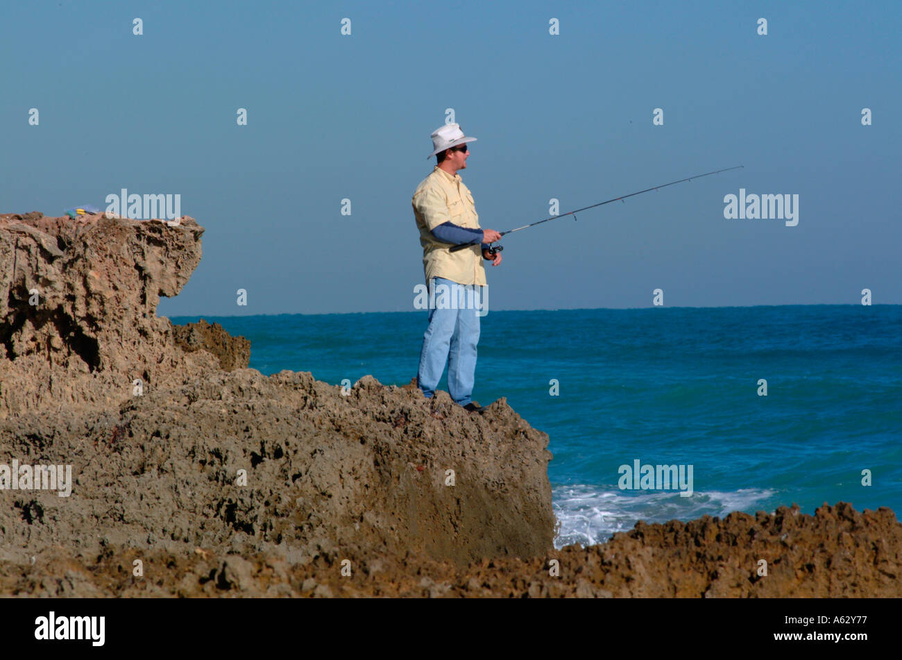 Man fishing on limestone shoreline of Hutchinson Island Stuart Martin ...