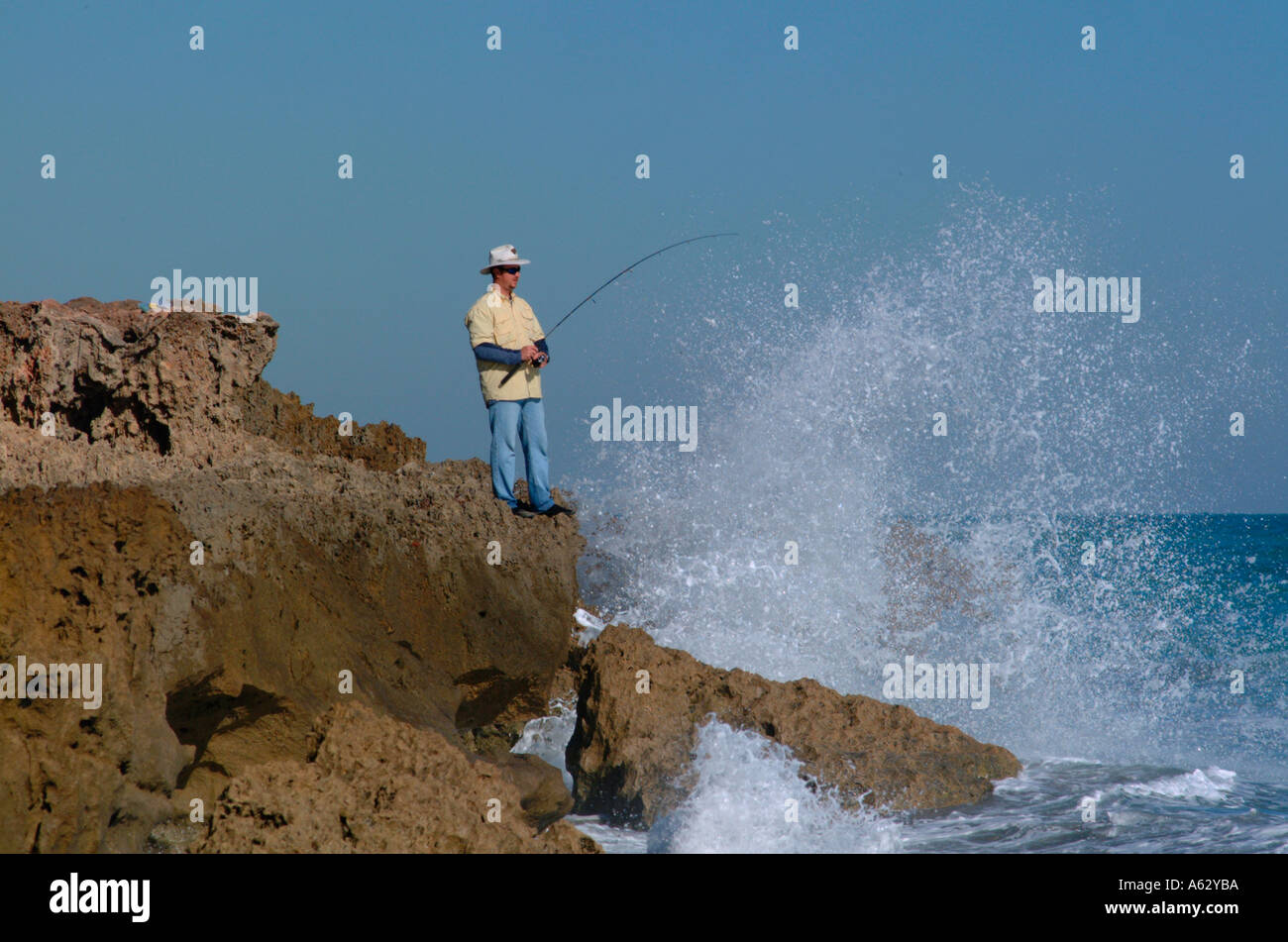 Man fishing on limestone shoreline of Hutchinson Island Stuart Martin ...