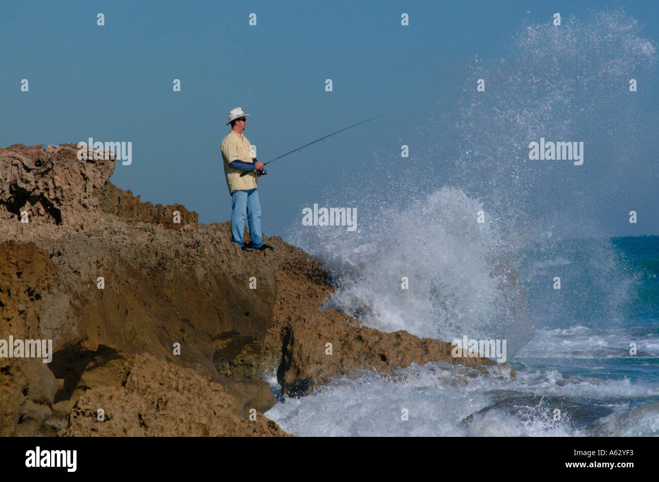 Man fishing on limestone shoreline of Hutchinson Island Stuart Martin ...