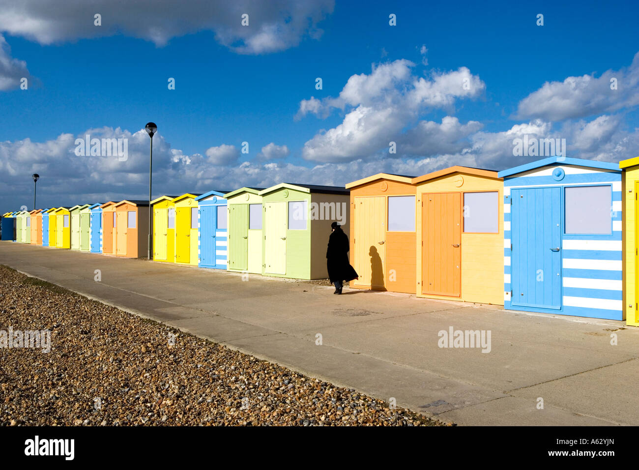 Woman standing by beach huts Stock Photo - Alamy