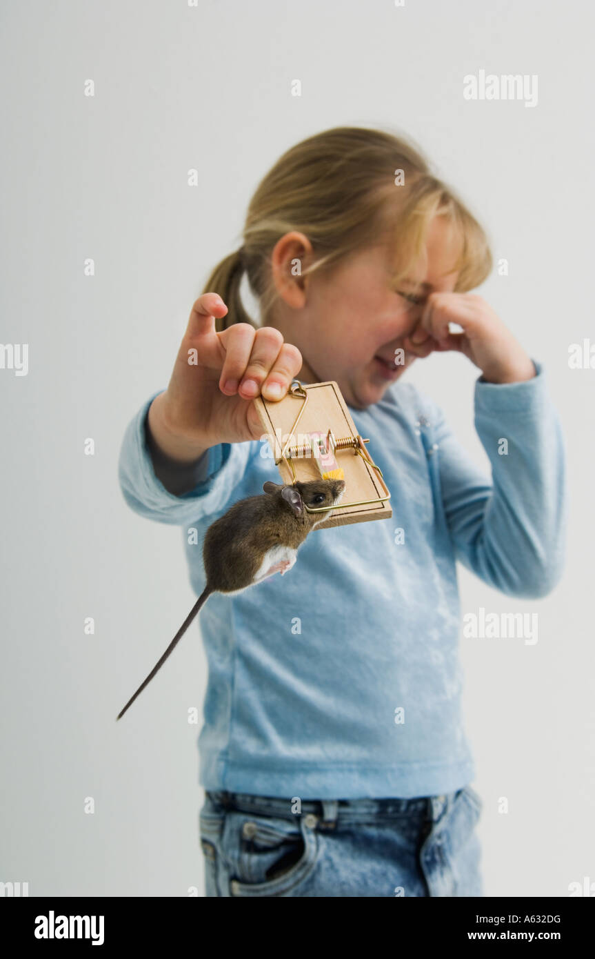 Child holding mouse in mousetrap Stock Photo - Alamy