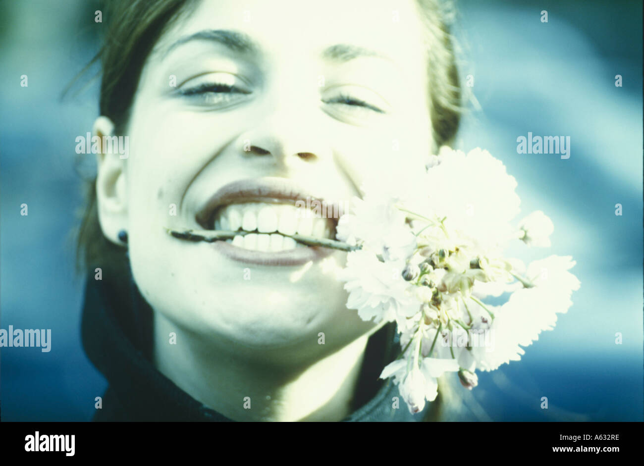 Woman holding flower with her teeth hi-res stock photography and images ...