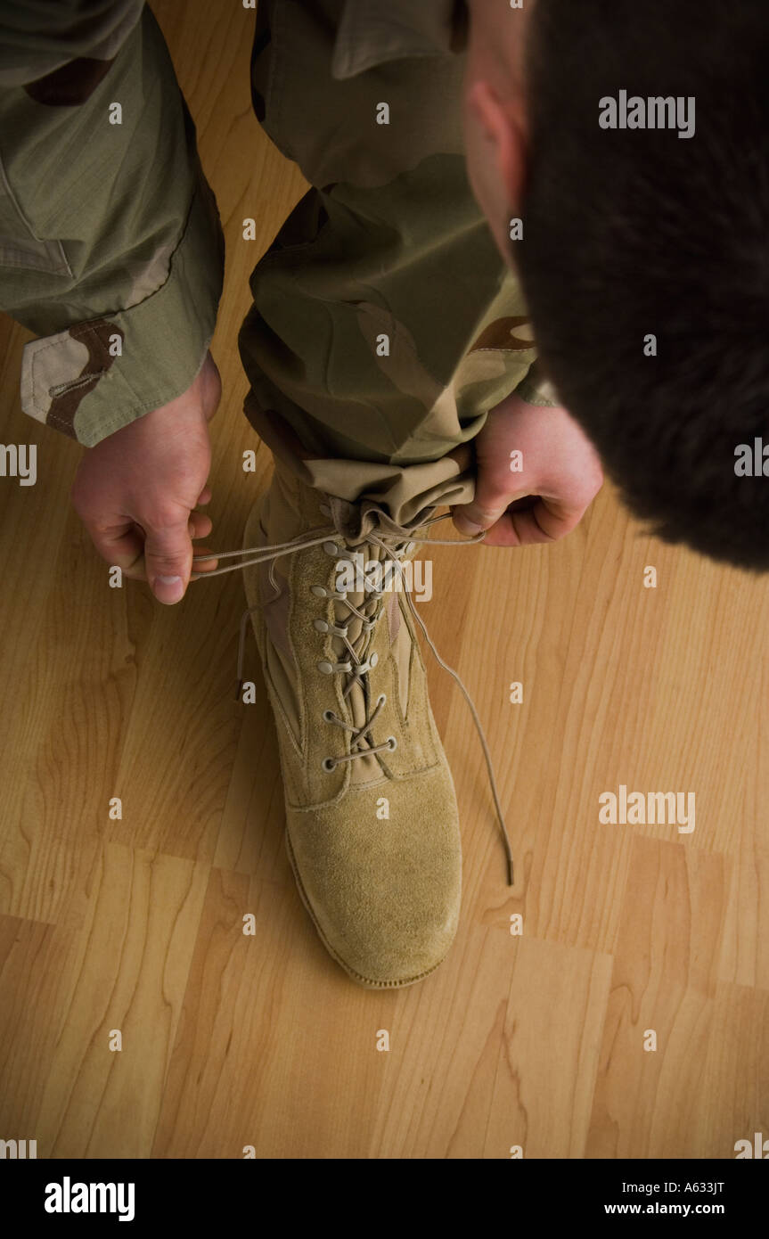 Military man tying shoes Stock Photo - Alamy
