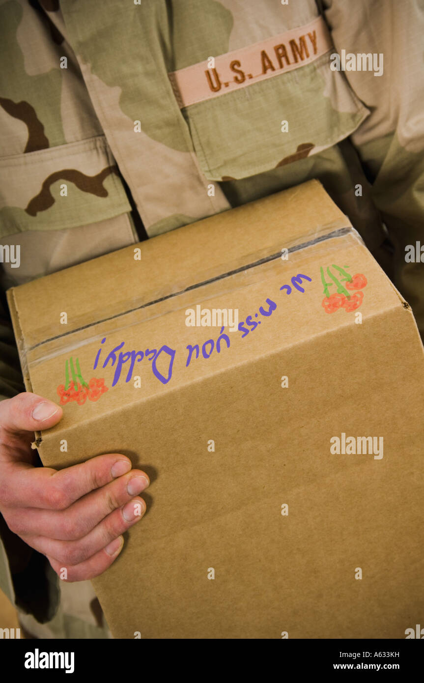 Military man with care package Stock Photo - Alamy