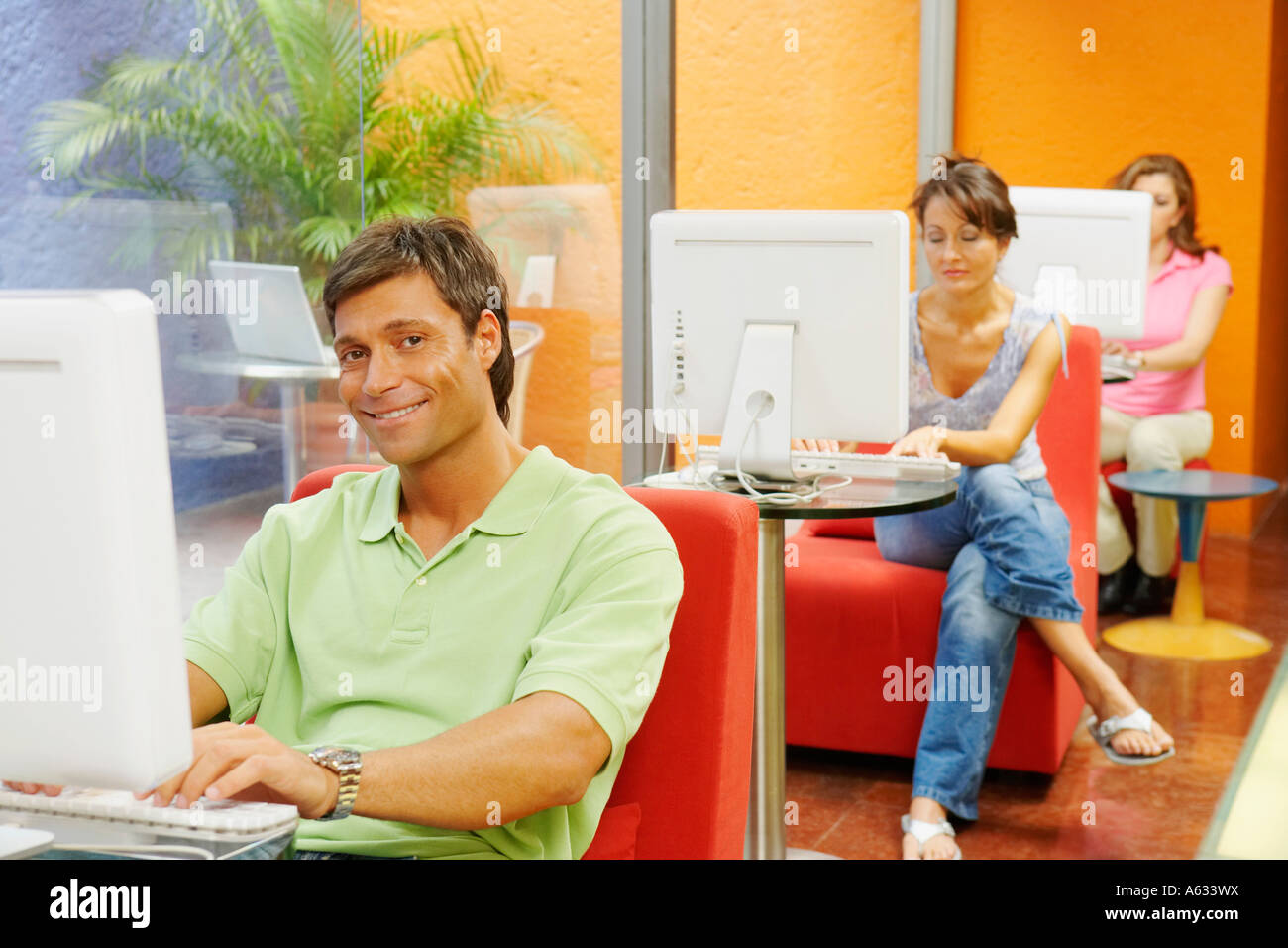 Three office workers working in an office Stock Photo - Alamy
