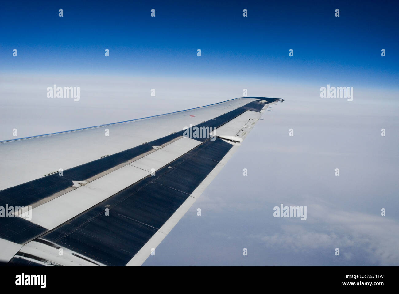 Wing of airplane out of window Stock Photo - Alamy