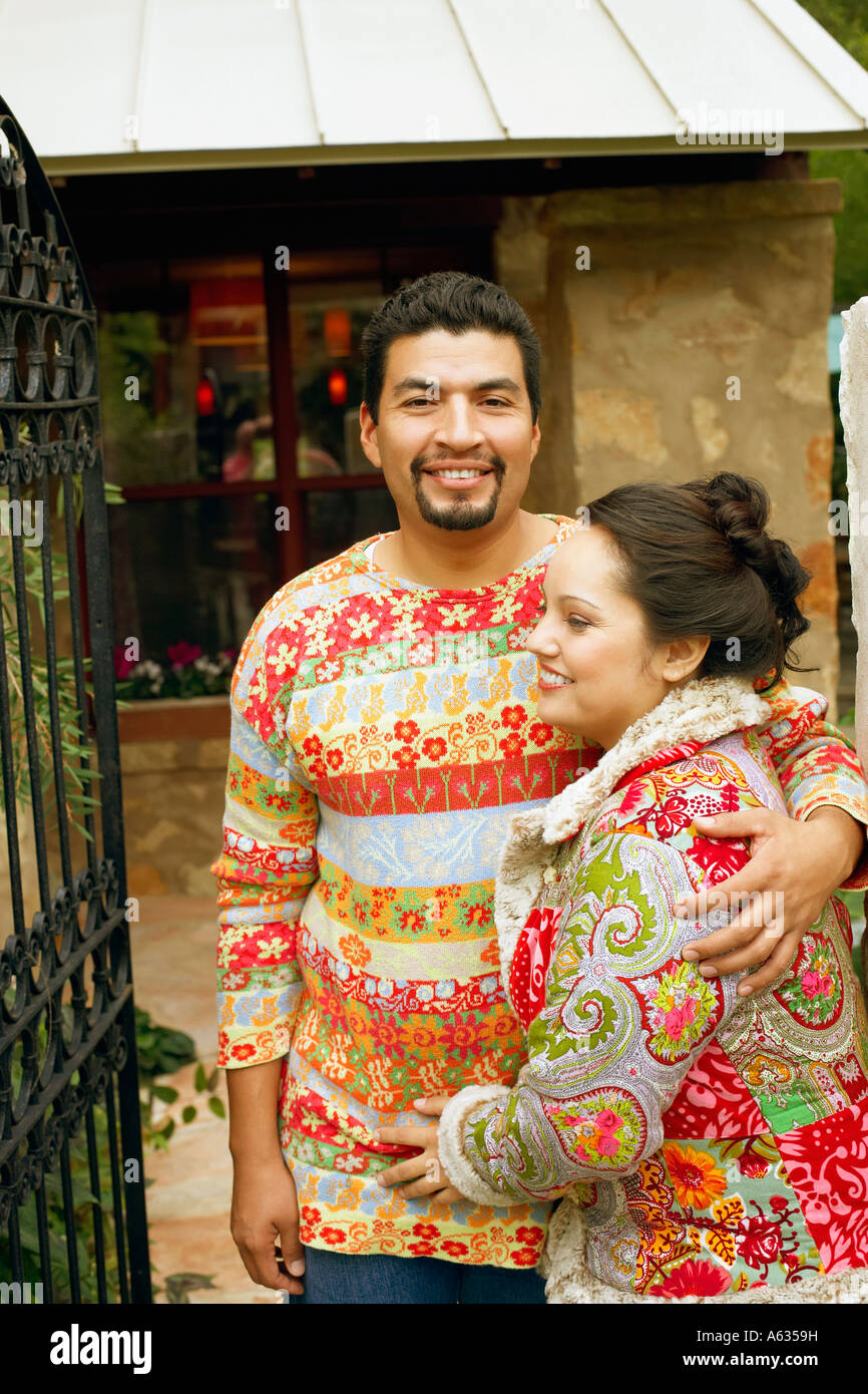 Mid adult couple embracing and smiling Stock Photo - Alamy