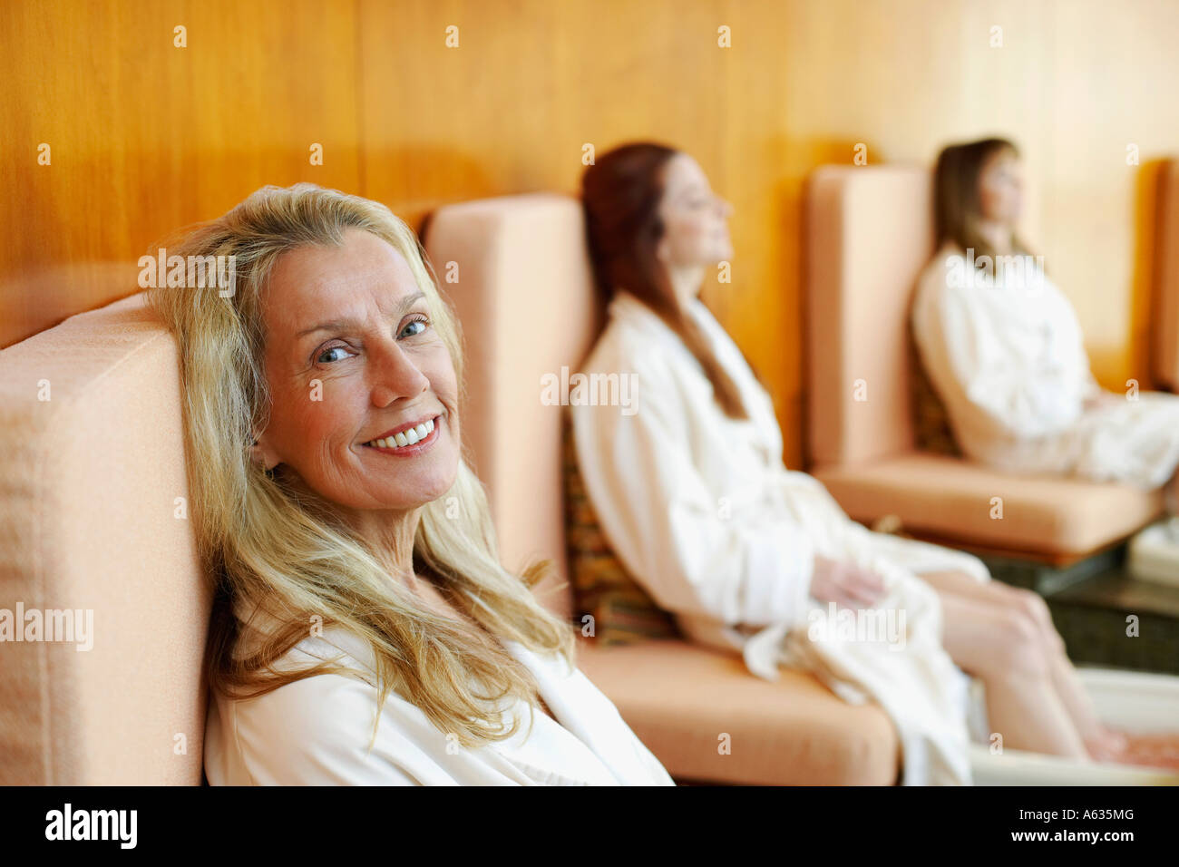 Three mature women getting pedicure in a beauty parlor Stock Photo - Alamy