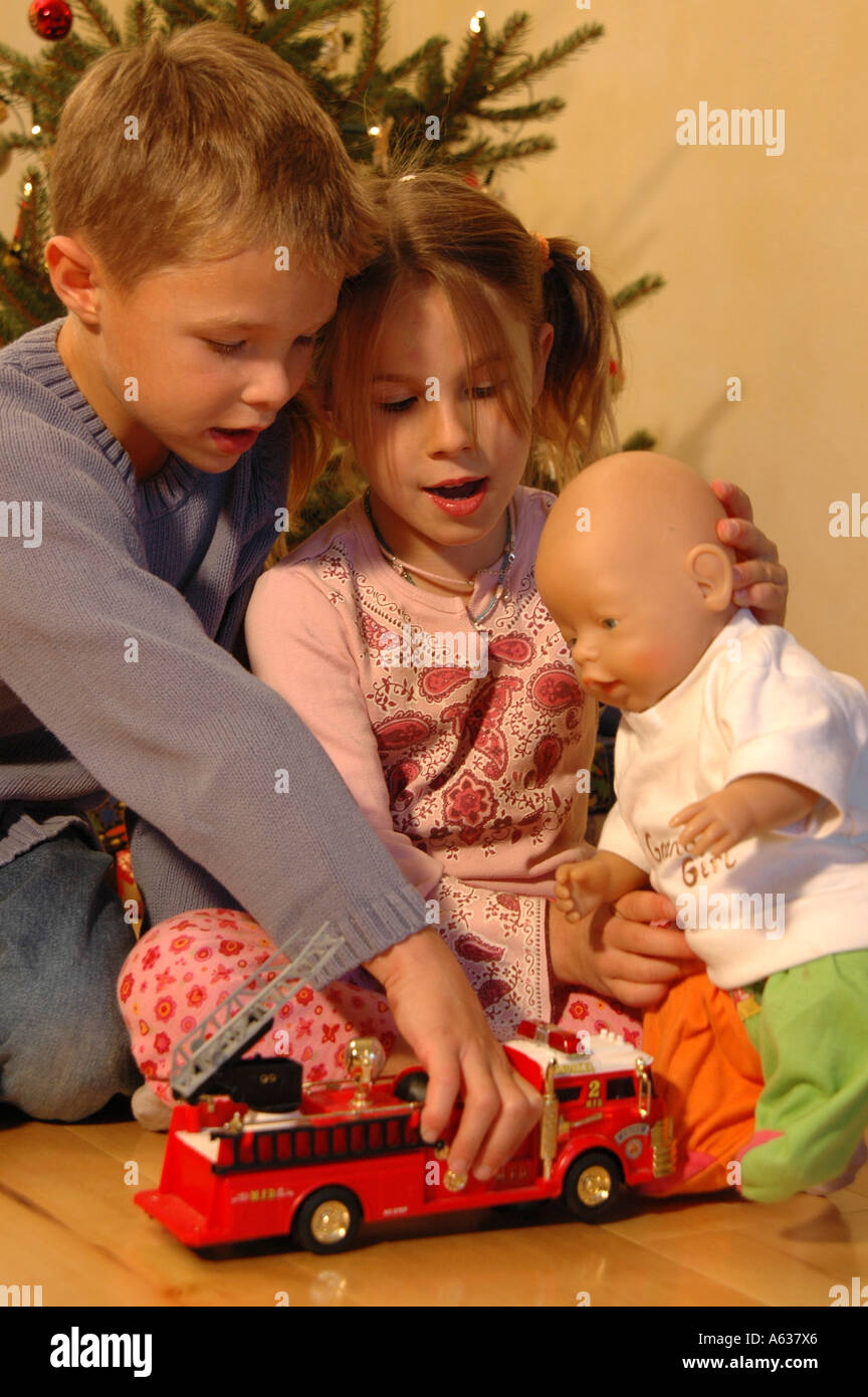 Brother and sister playing with toys Stock Photo - Alamy