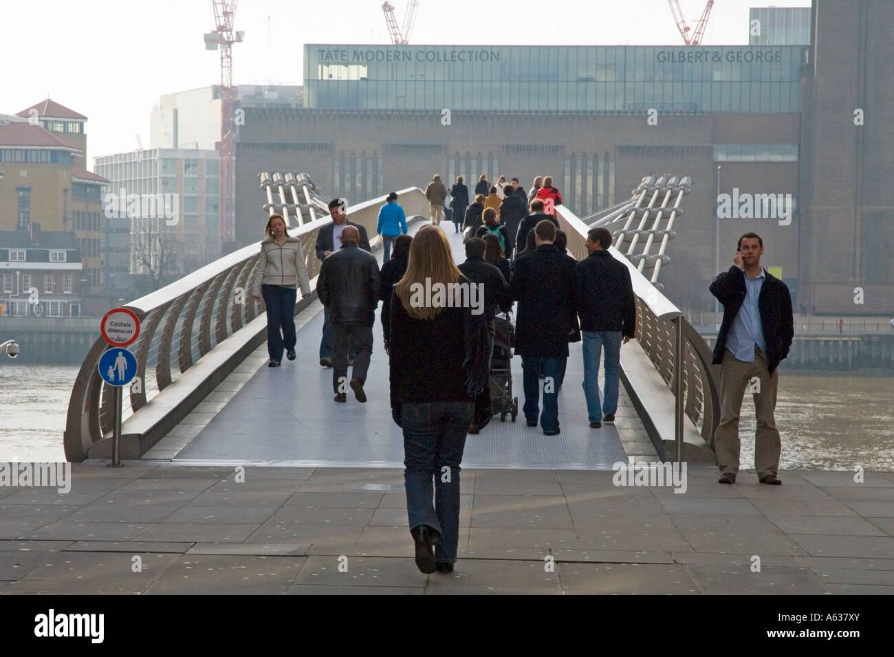 People crossing the Millenium Bridge London to get to the Tate Modern ...