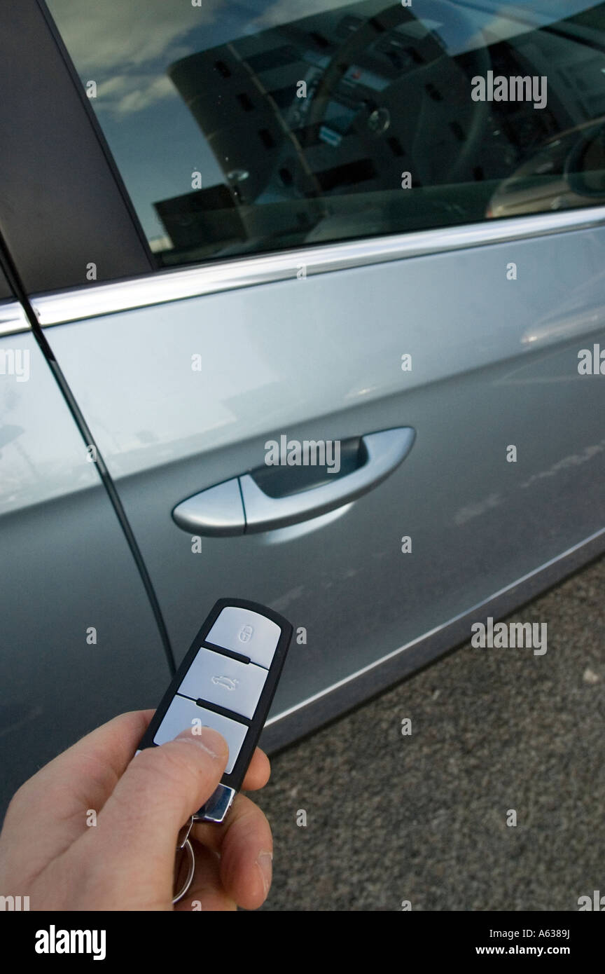 Mans hand holding the electronic key fob of a new car Stock Photo - Alamy