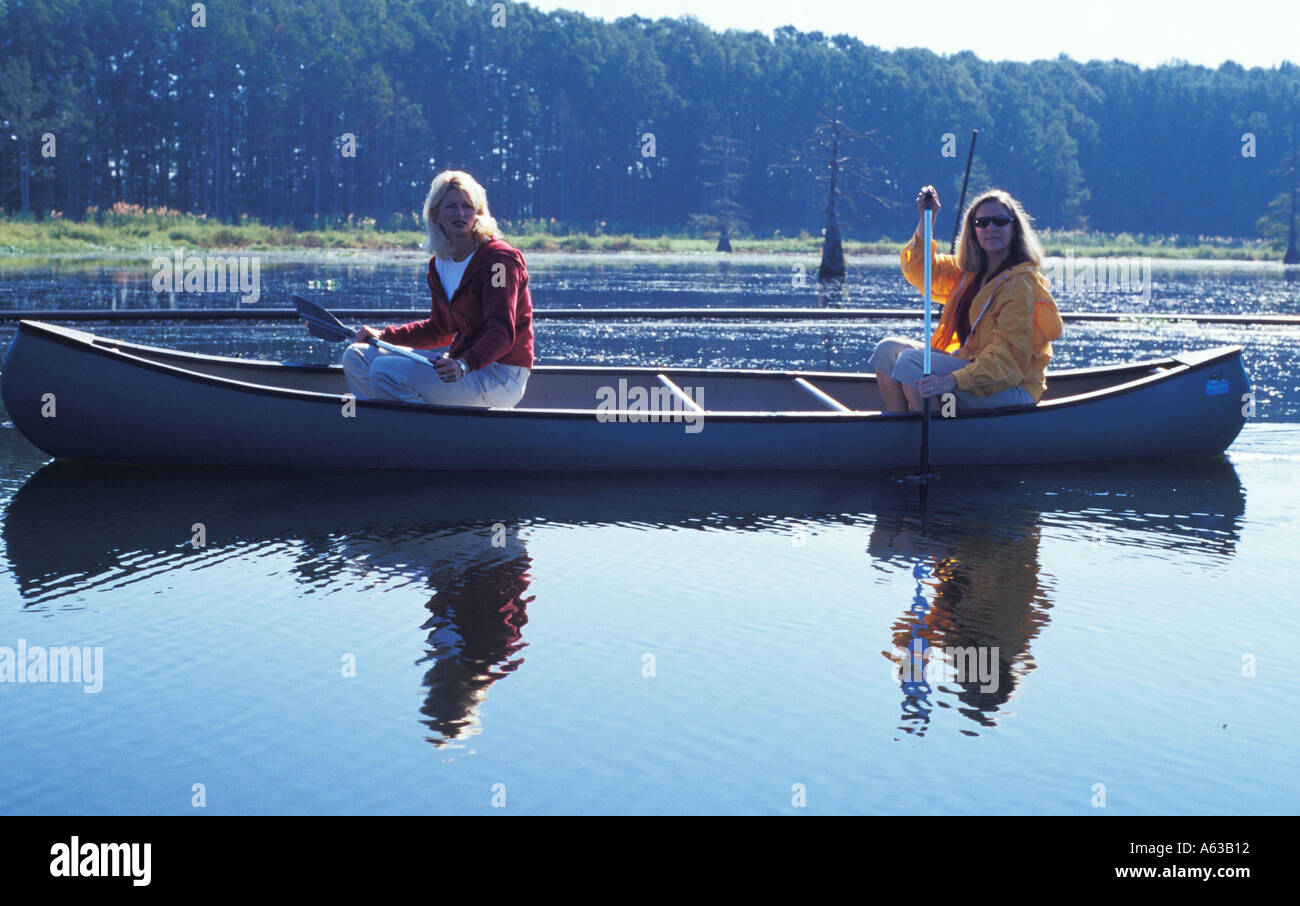 Two young beautiful blonde models in canoe in Black Bayou Lake near ...