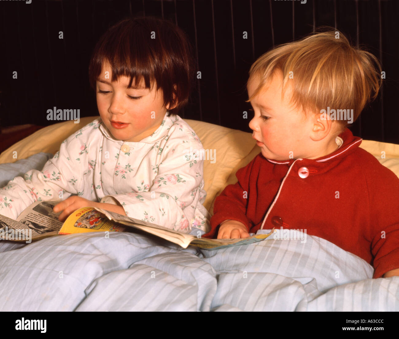 Children reading bedtime story Stock Photo - Alamy