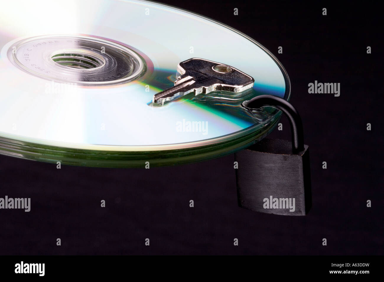 Concept data security, single DVD with key isolated on black baclground ...
