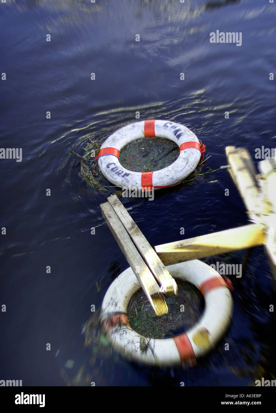 lifebuoys floating in river Stock Photo - Alamy