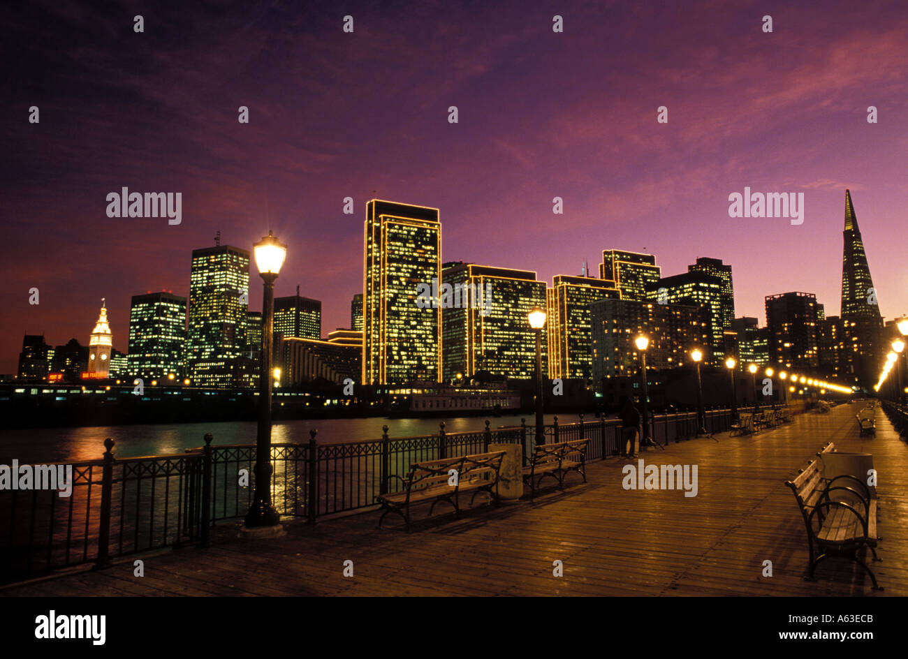 San Francisco sunset skyline in California with reflection in bay water ...