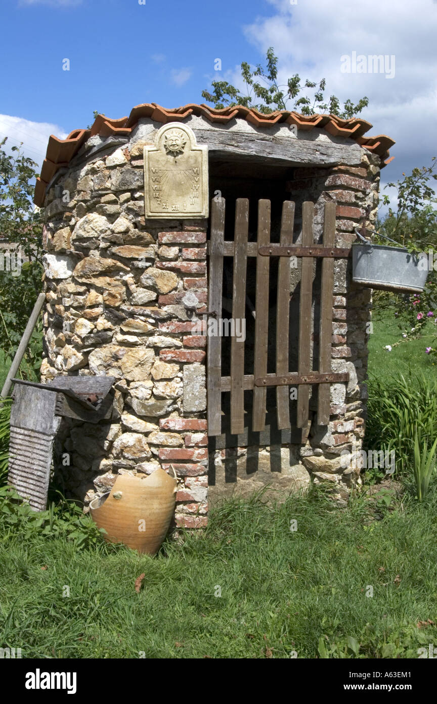 A traditional brick built deep water well in garden in France Stock ...